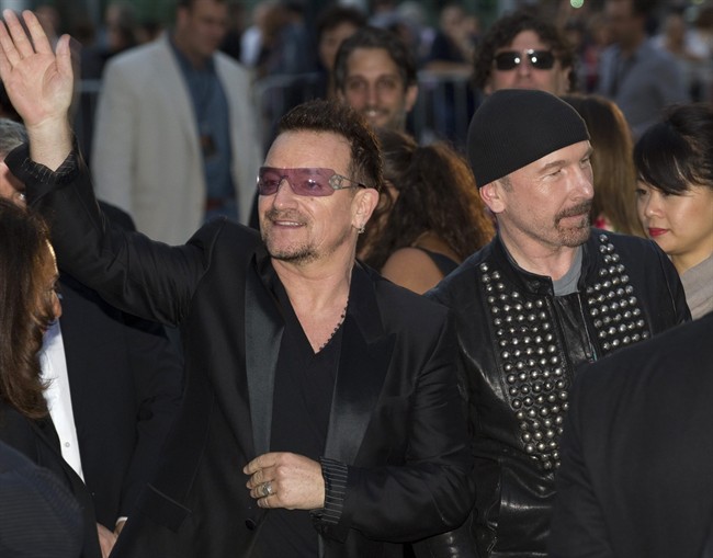 Screaming fans greet Bono and Edge at Toronto International Film ...