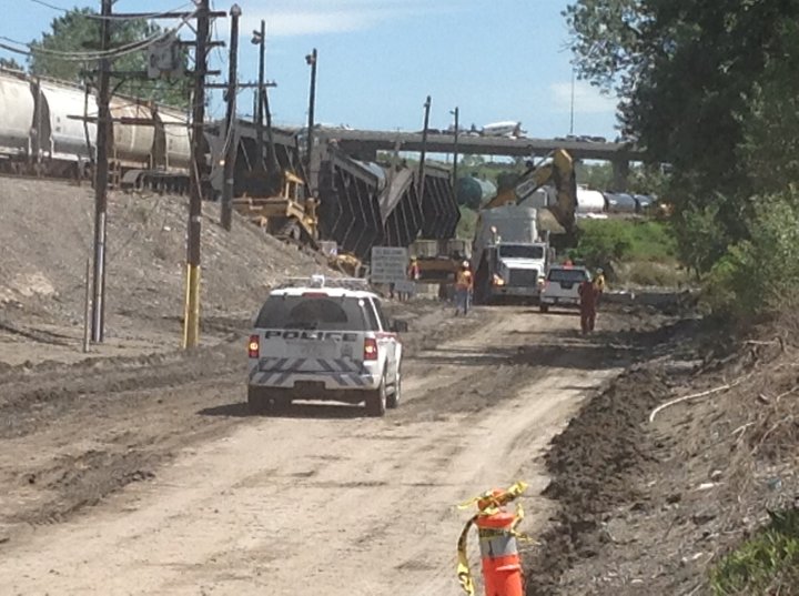 Teetering train cars successfully removed from partially collapsed ...