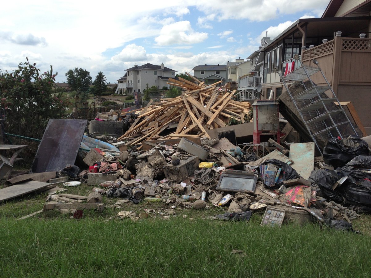 Garbage piles up in High River as residents finally begin flood cleanup ...