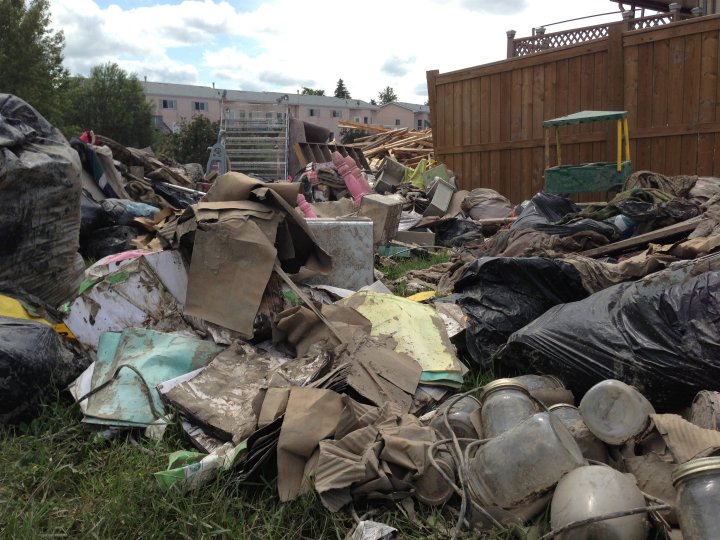 Garbage piles up in High River as residents finally begin flood cleanup ...