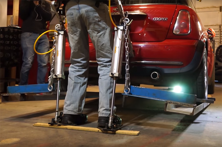 Canadian Iron Man demonstrates homemade exoskeleton by lifting a car ...