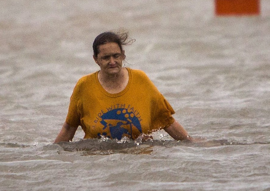 Hurricane Matthew: Homeless woman wades through neck-high floodwater to ...