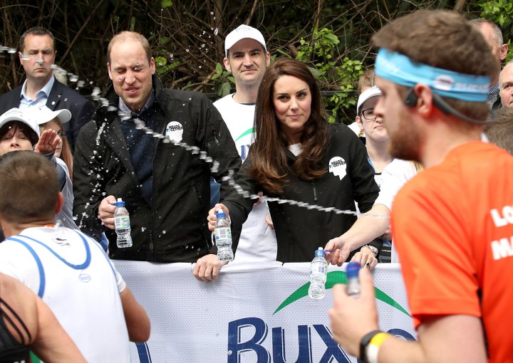 Runner douses Prince William with water during London Marathon as Kate ...