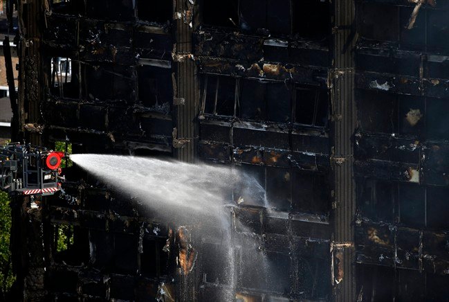 London Fire: British PM Theresa May rushed away by police as protesters ...