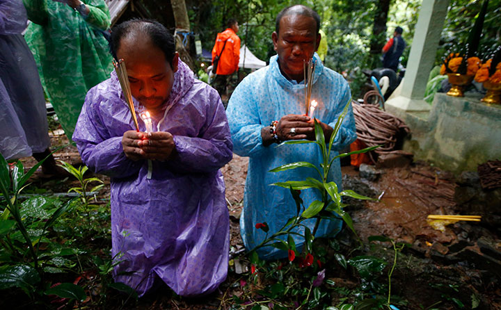 IN PHOTOS: Rescue teams slog through mud, pouring rain to reach boys ...