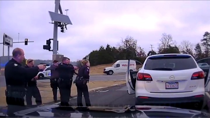 Police dashcam video shows officer rescuing baby during standoff ...