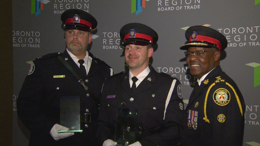 Toronto cops who saved 2 men trapped in elevator during flash flood ...