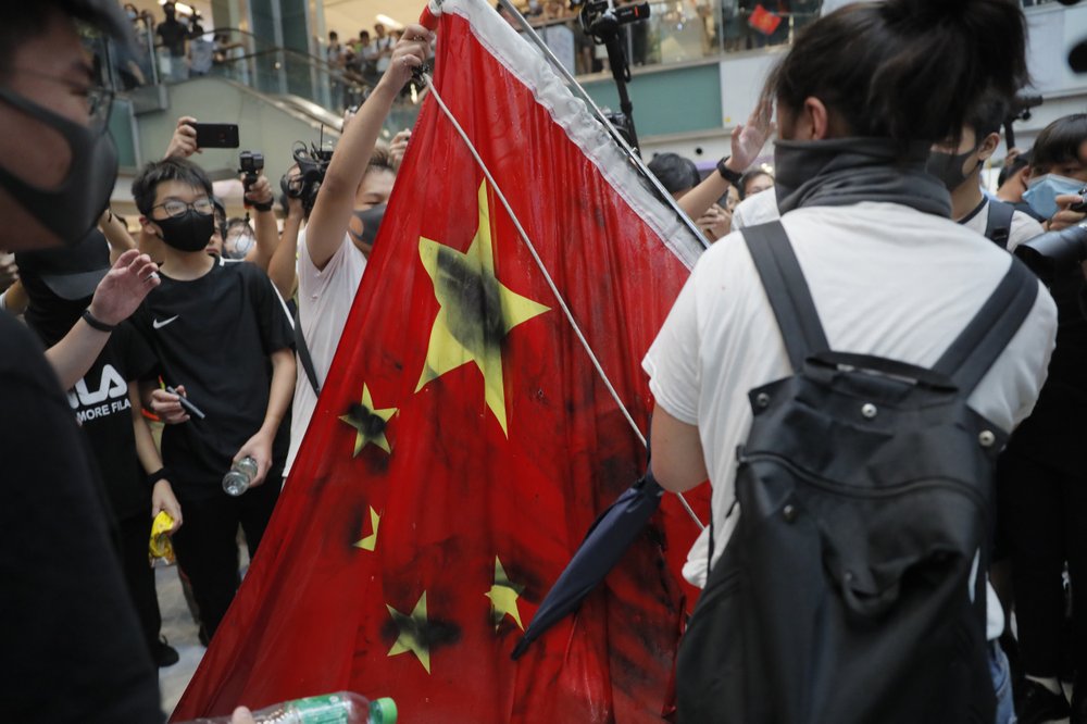 Hong Kong protesters trample Chinese flag, set fires as violence ...