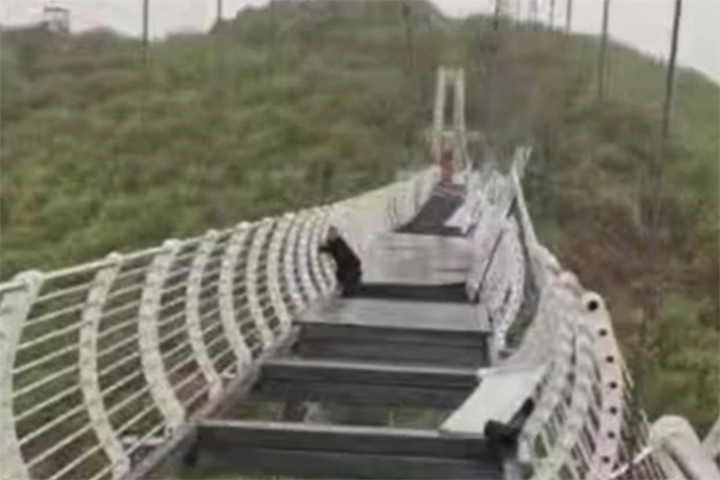 Wind shatters glass bridge in China, leaving tourist stranded over drop ...