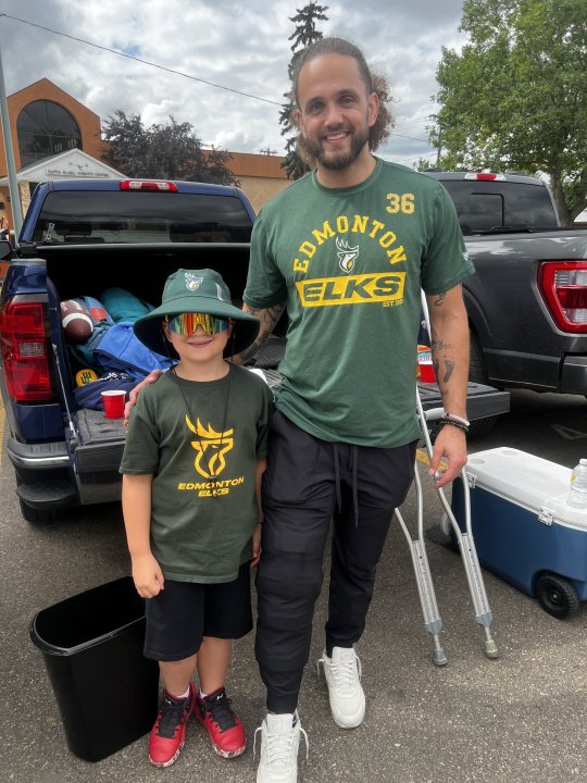 Football-loving kid and former Edmonton Elks player lean on each other ...